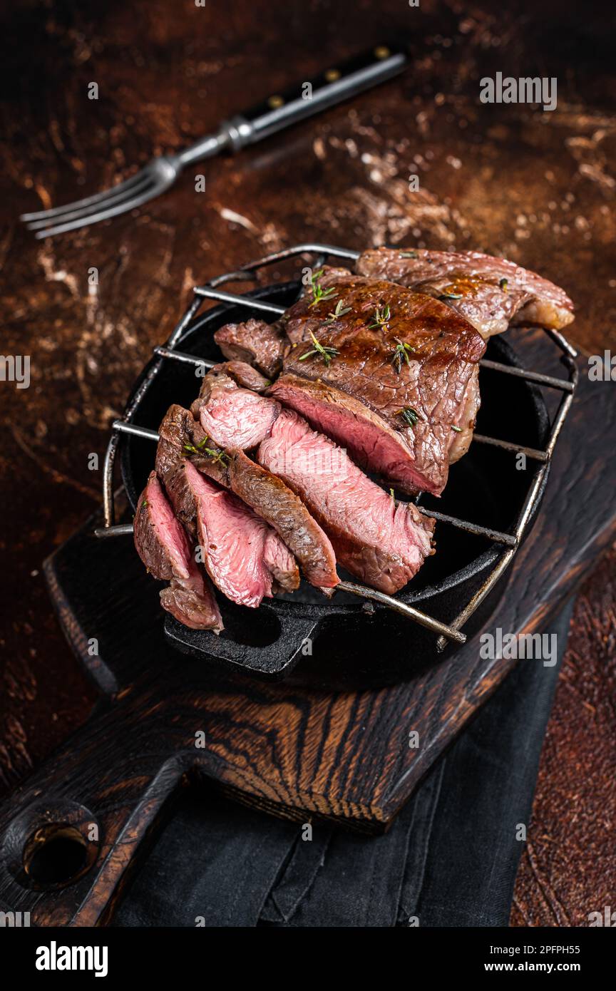 BBQ grilled Mutton fillet chop steaks, sliced lamb meat. Dark ...