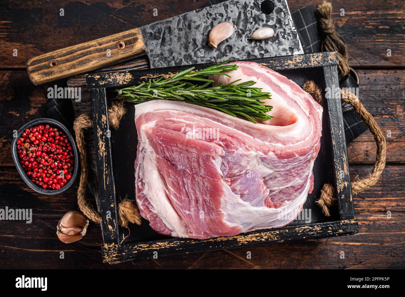 Organic uncooked Pork belly, raw bacon meat in a wooden plate with ...