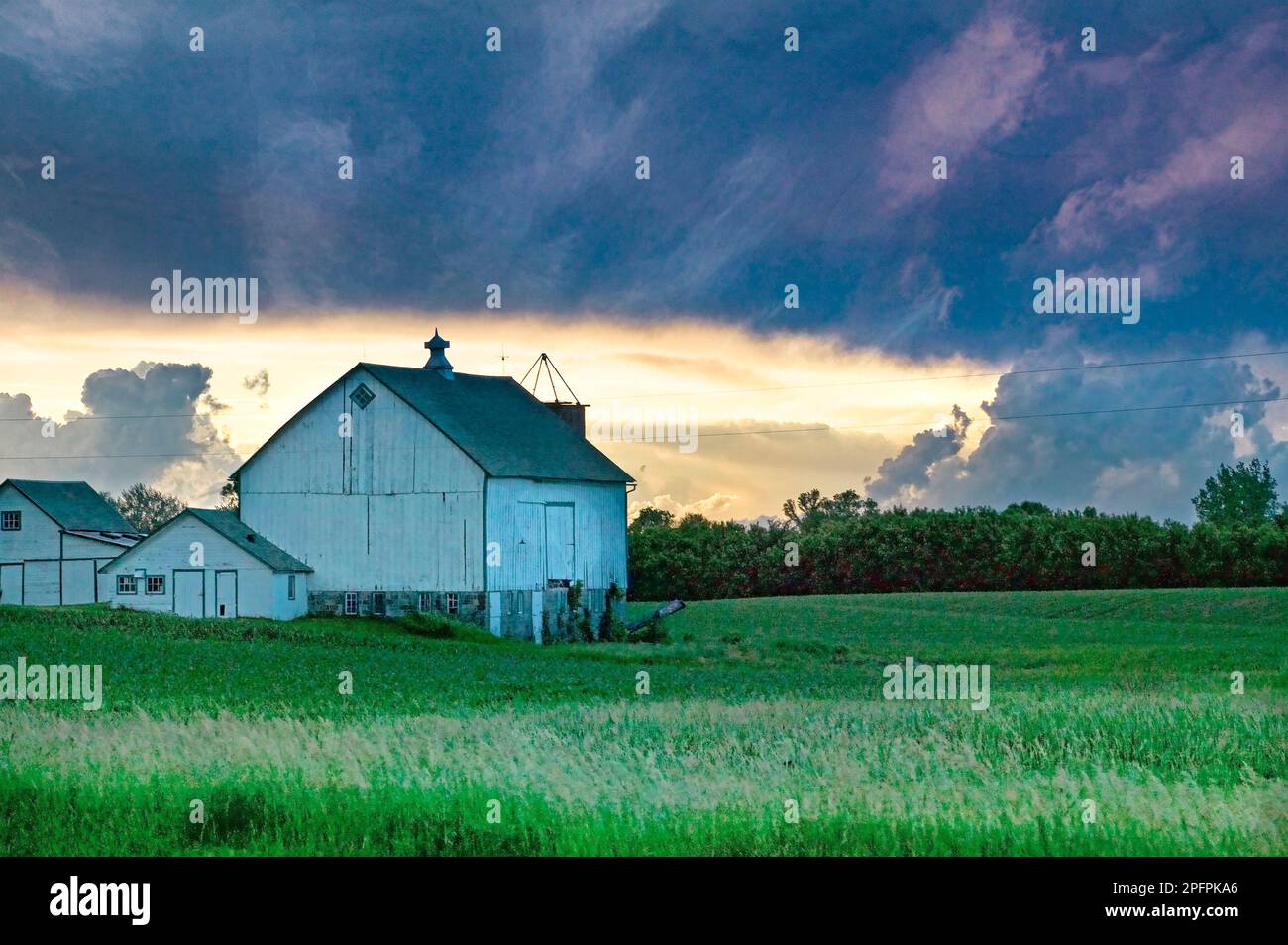 A storm brews over a farm house at a rural Minnesota farm Stock Photo ...
