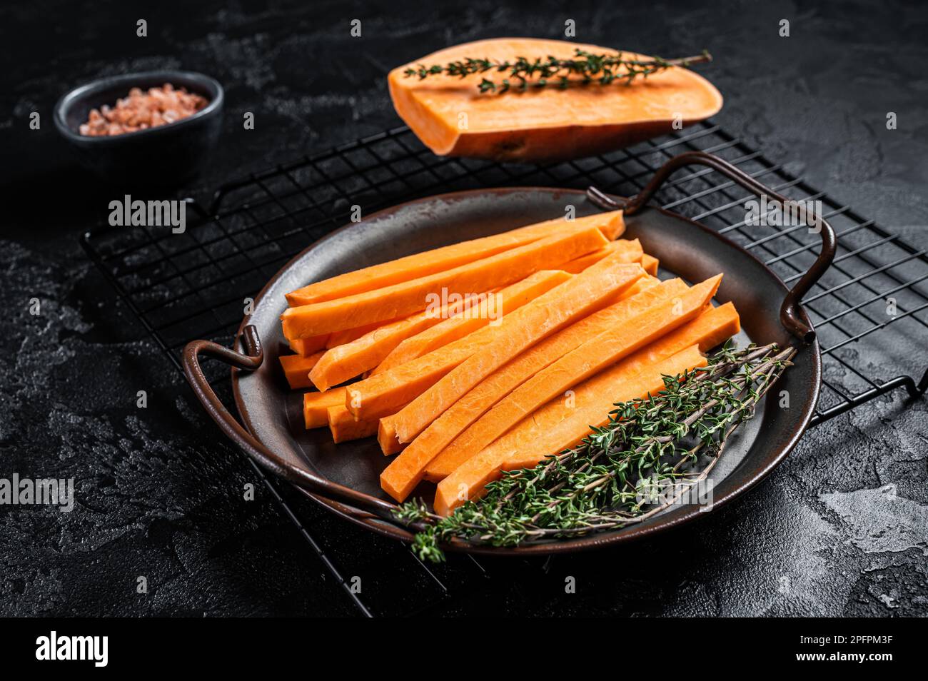 Sliced Sweet potatoes in a steel tray, fresh batata fries ready for ...