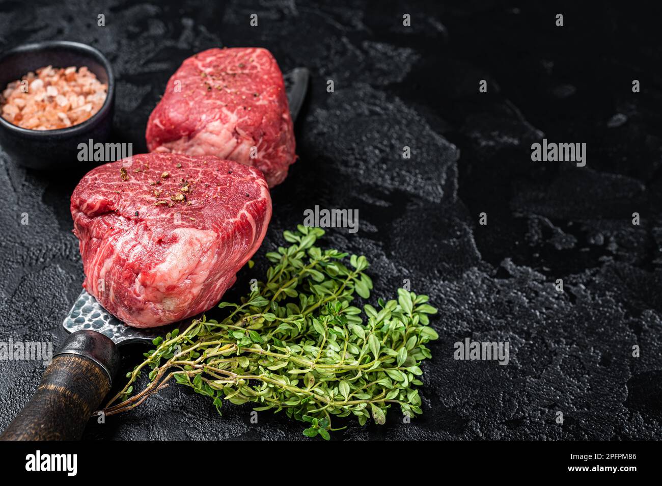 Fillet Mignon Beef steak, raw dry aged marble meat. Black background ...