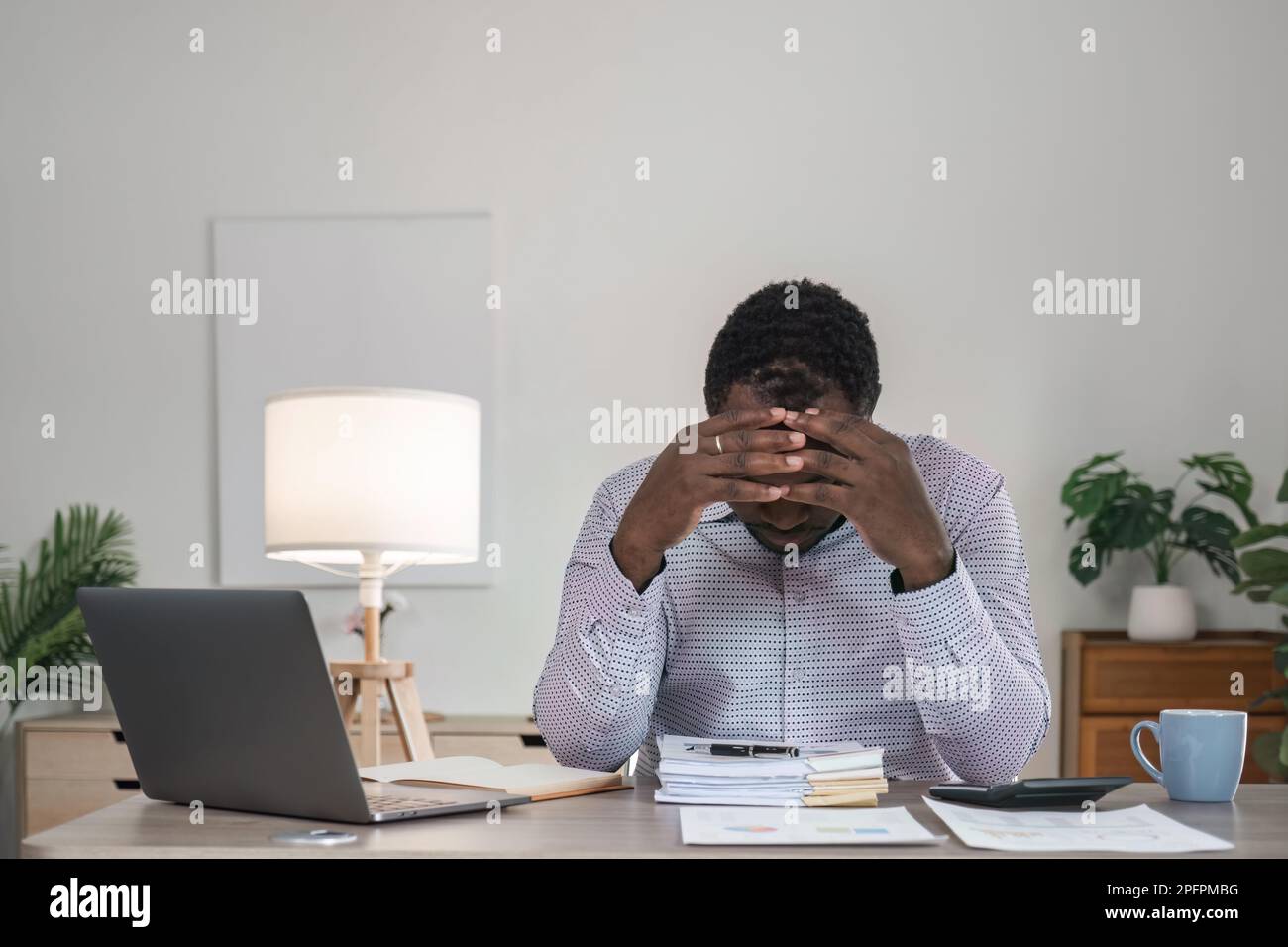 Stressed business man sitting at office workplace. Tired and overworked ...