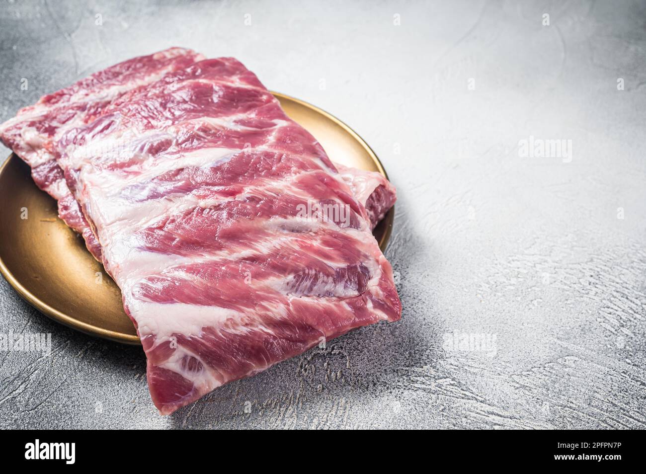 Rack of raw pork spare ribs. White background. Top view. Copy space ...