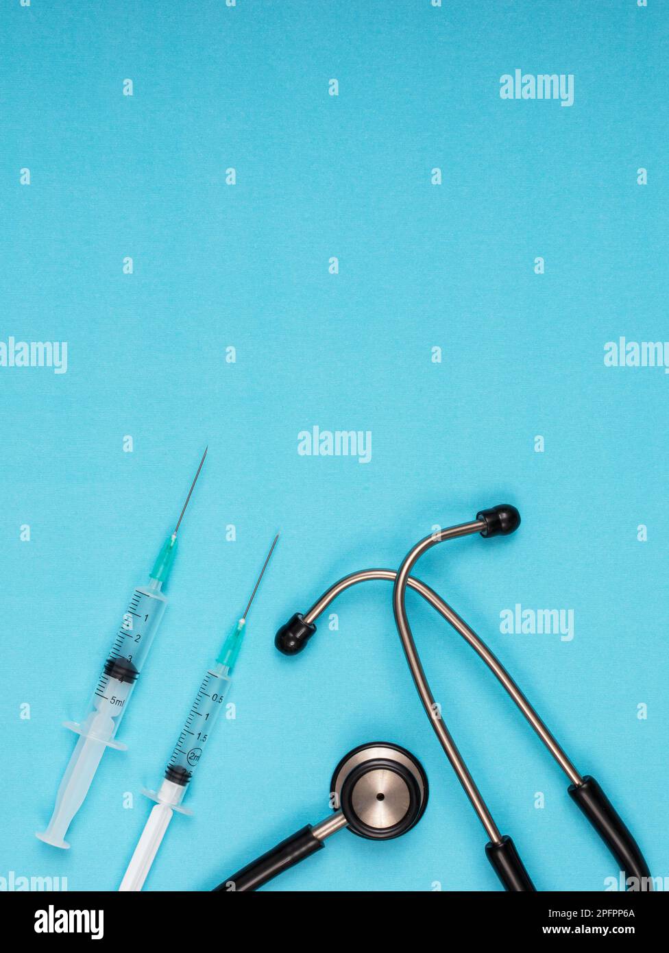 stethoscope, needle, vaccine standing on blue background Stock Photo ...