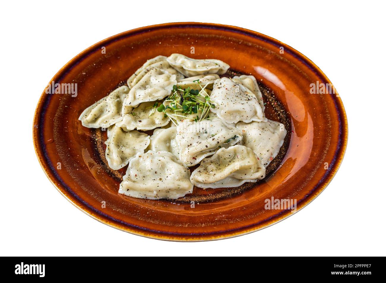 Polish Pierogi Dumplings with potato in a plate with herbs and butter ...