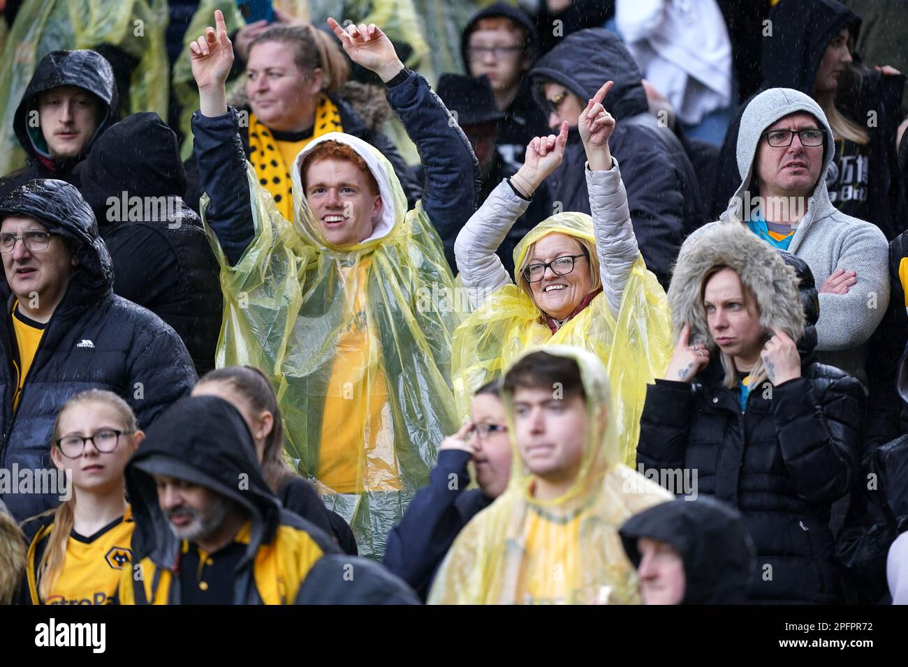 Wolverhampton Wanderers fans shield themselves from the rain during the ...
