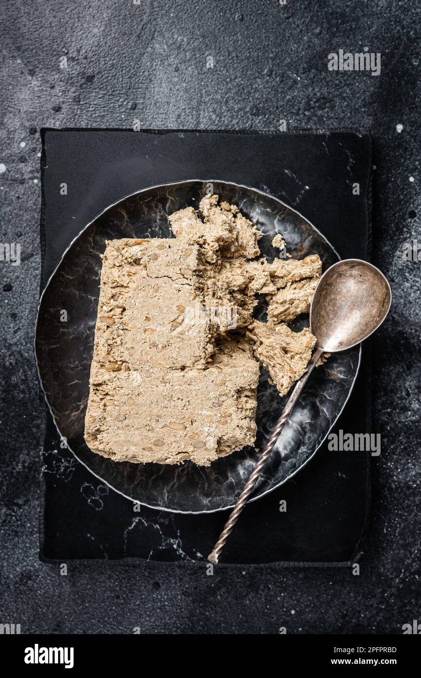 Homemade sunflower halva with honey. Black background. Top view Stock Photo - Alamy