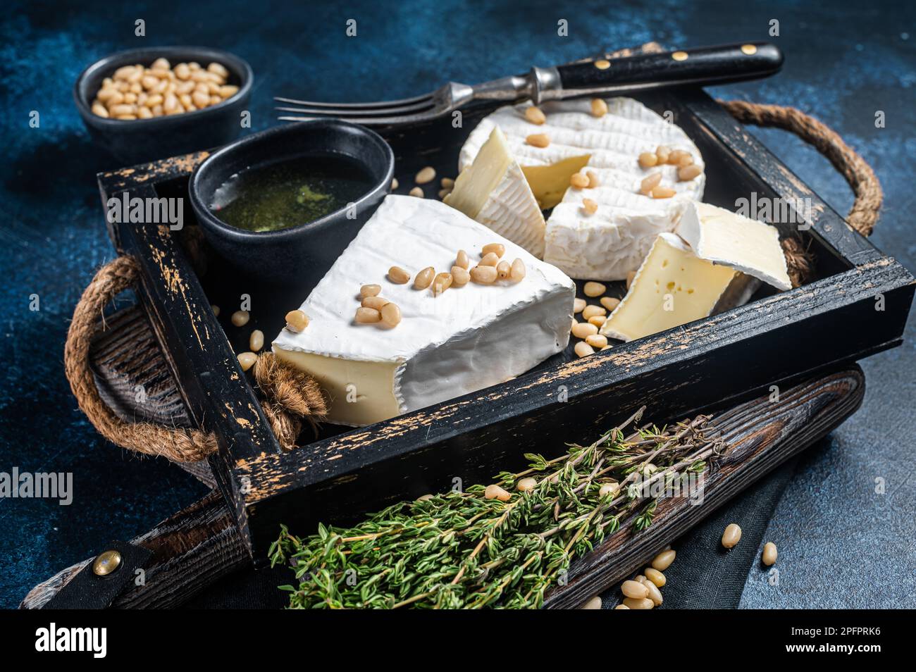 Cheese platter with brie and camembert, wooden tray with nuts. French ...