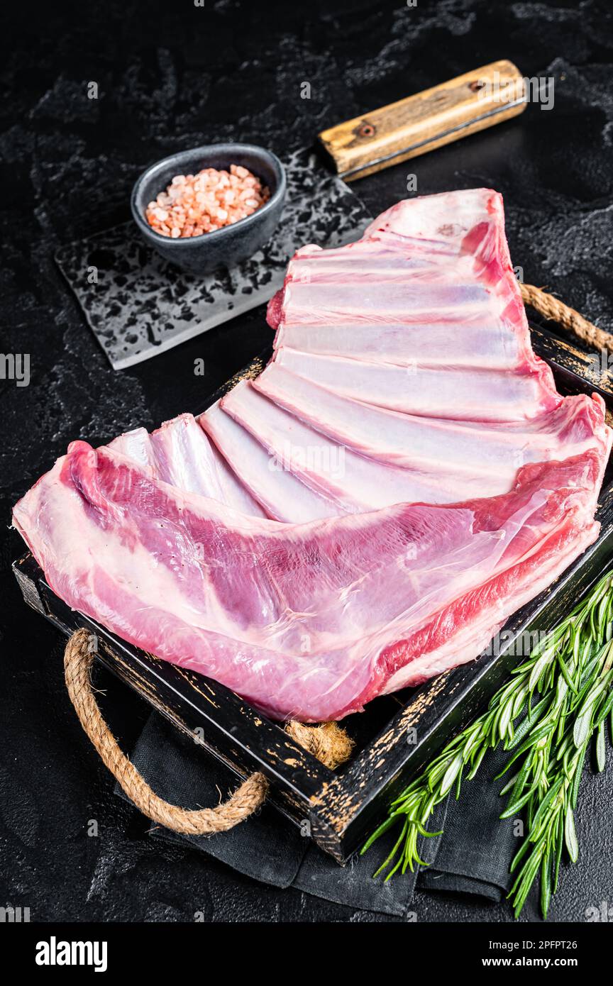 Butcher table with Rack of lamb, raw mutton ribs with meat cleaver ...