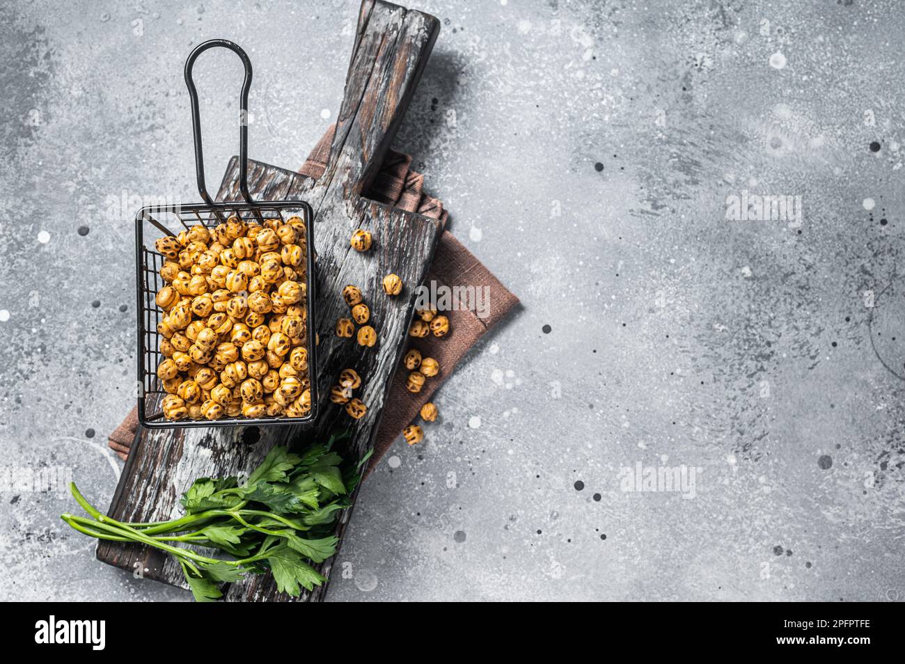 Healthy snack roasted spicy chickpeas in a basket. Gray background. Top ...