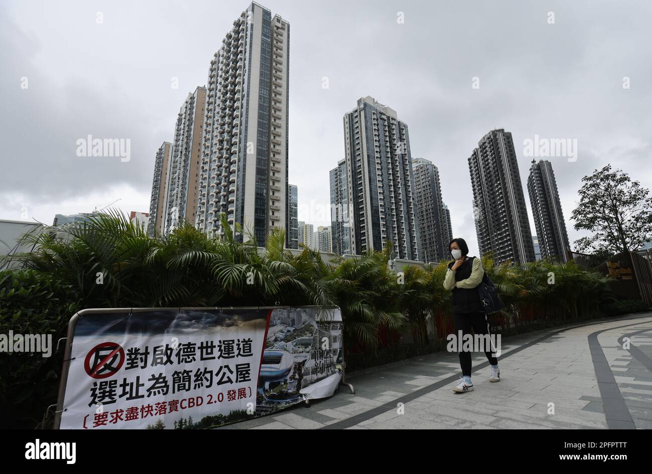 People walk past a banner with the message disapproving a government ...