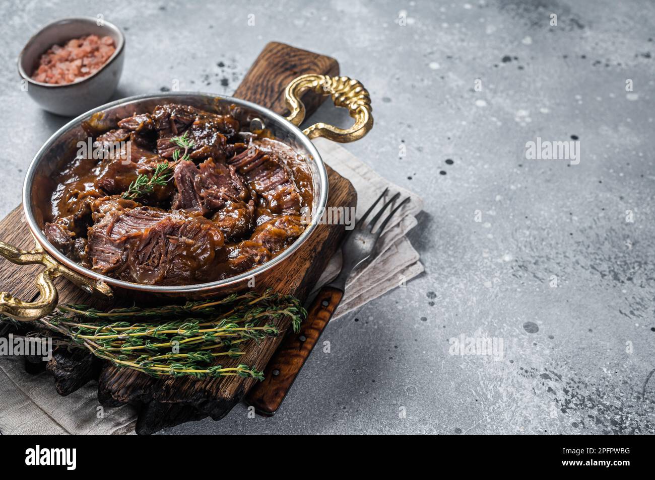 German braised beef cheeks in brown red wine sauce. Gray background ...