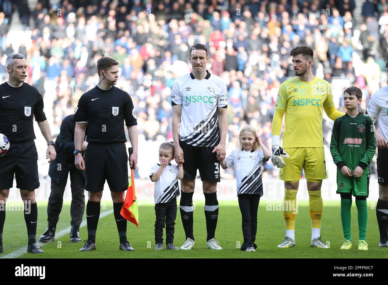 Derby County's Craig Forsyth (centre) and his children on the pitch ...