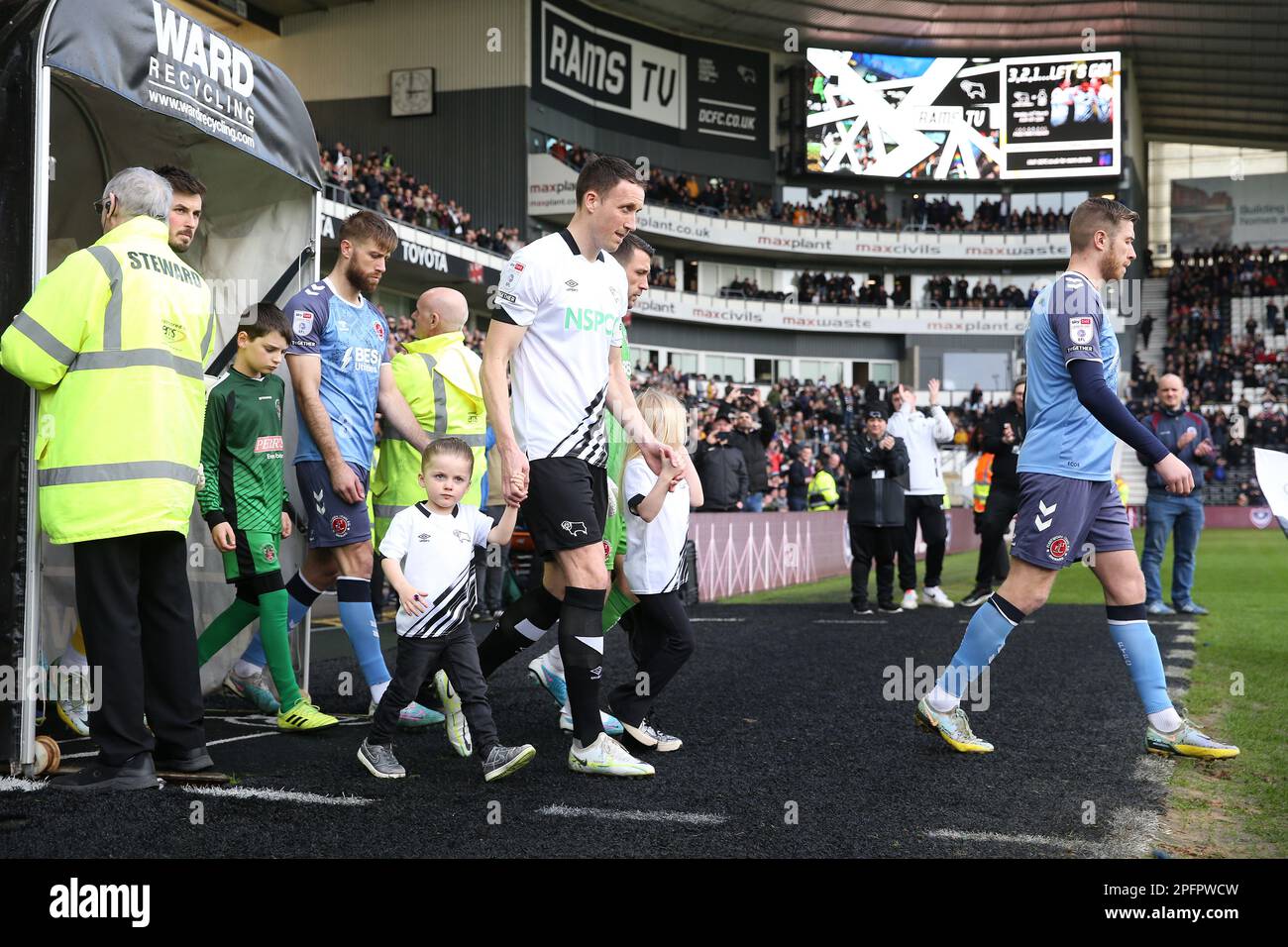 Derby County's Craig Forsyth (centre) with children leads his team on ...