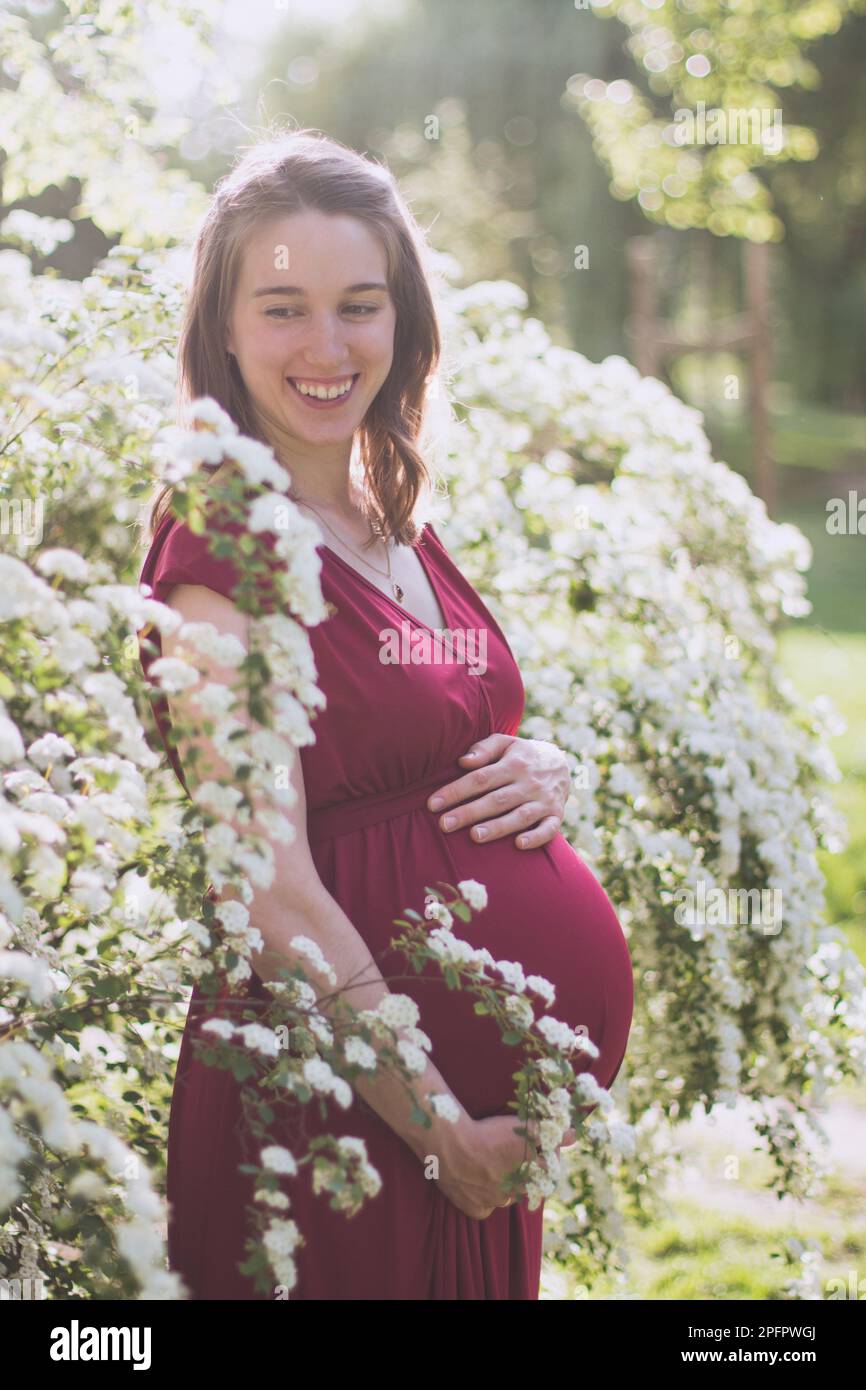 Young married woman expecting a baby soon, she is in the last trimester ...