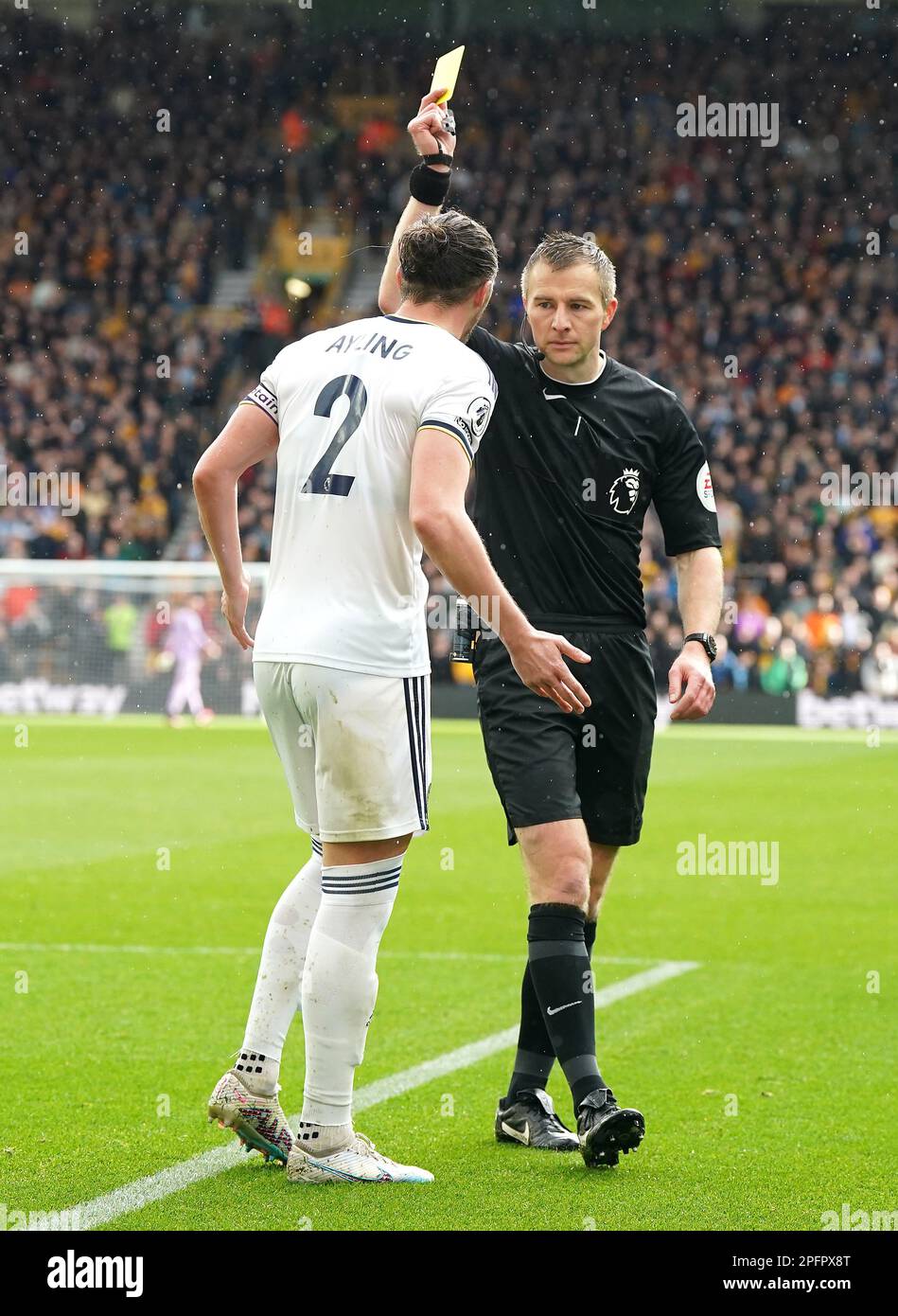 Referee Michael Salisbury (right) shows a yellow card to Leeds United's ...