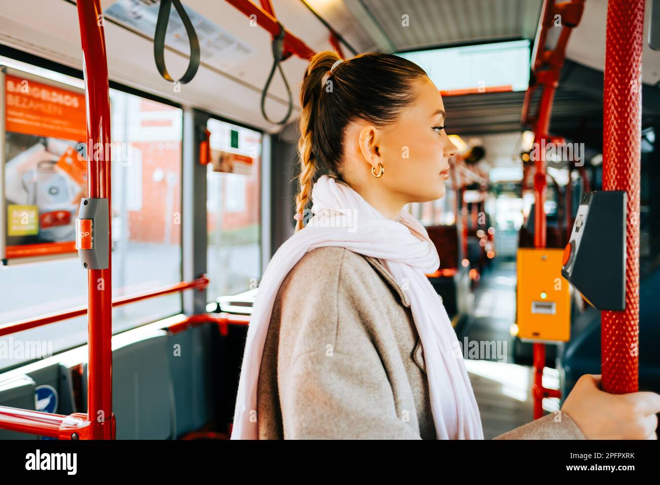 An attractive caucasian woman riding in a bus in the sunny day. Young ...