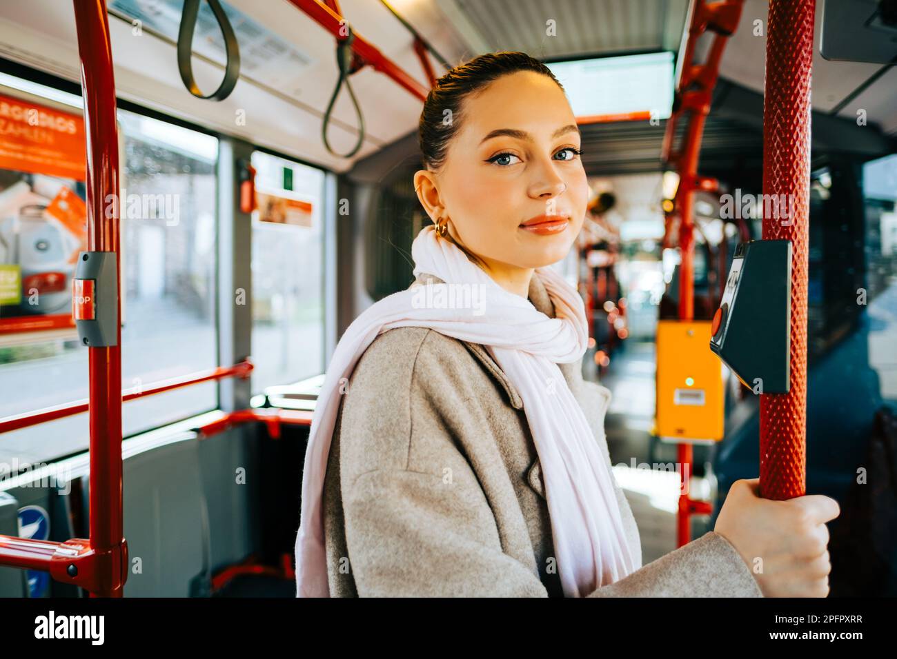 An attractive caucasian woman riding in a bus in the sunny day. Young ...