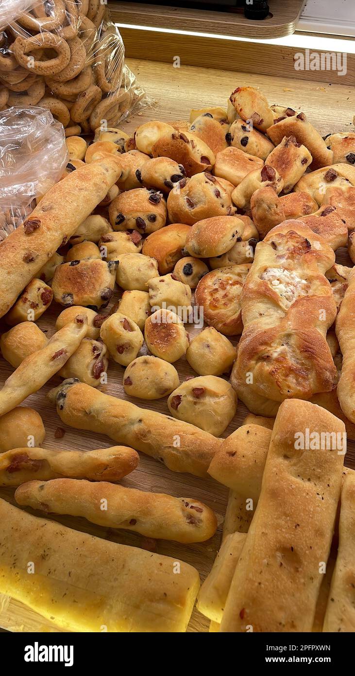Counter of an Italian bakery with various baked goods. Pucce, bread ...