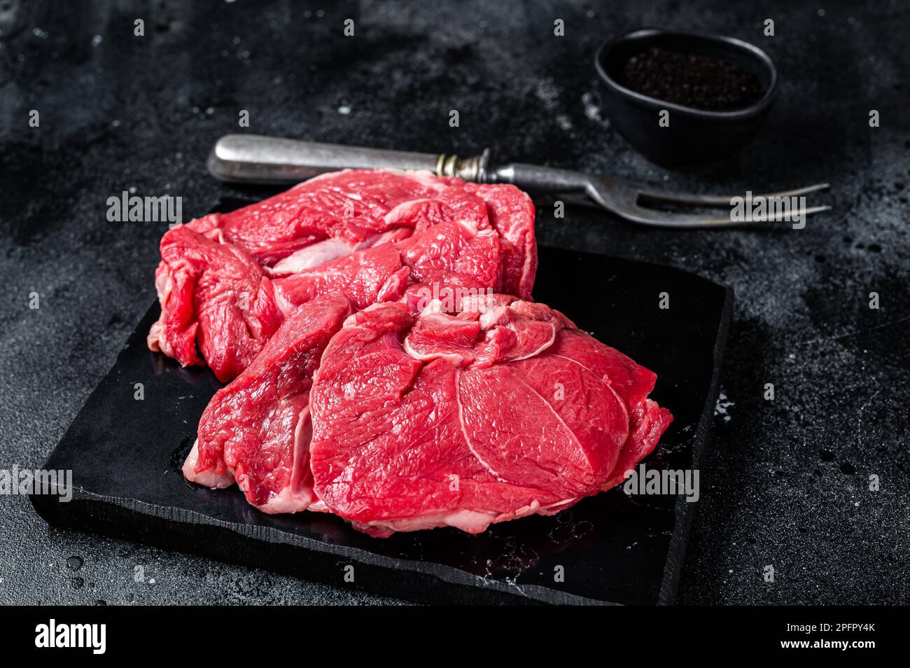 Raw Mutton fillet steaks from leg, uncooked lamb meat. Black background ...