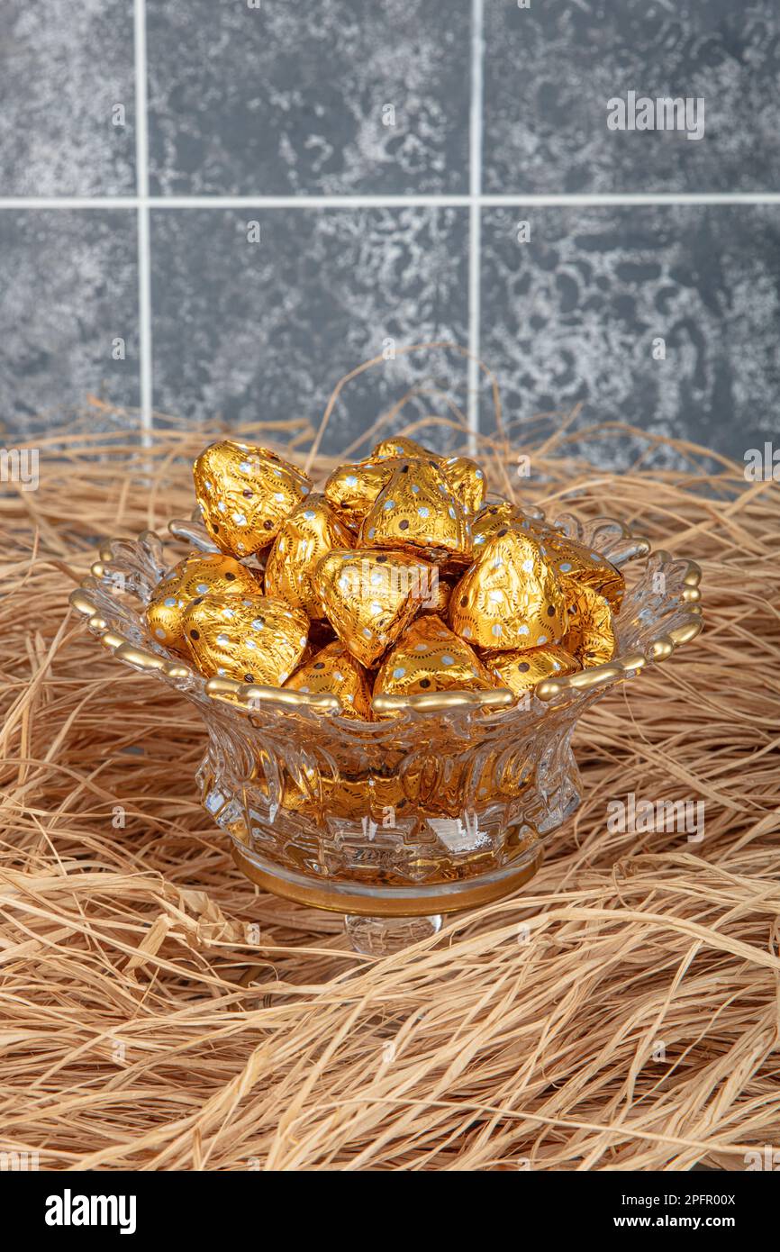 Chocolates wrapped in foil in luxury candy. Chocolate candies in a box ...