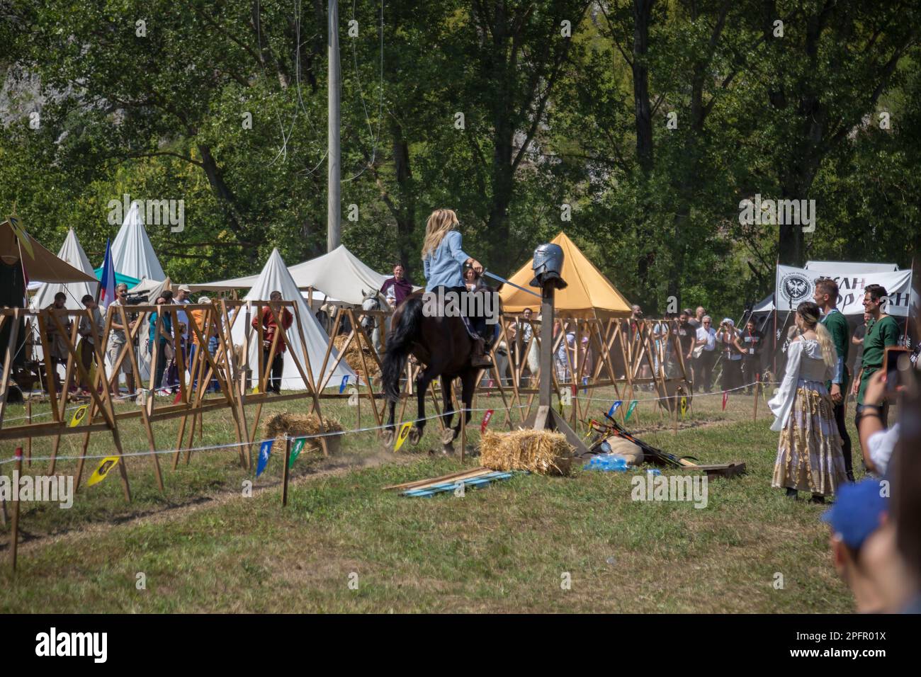 A girl riding a horse with a sword Stock Photo - Alamy
