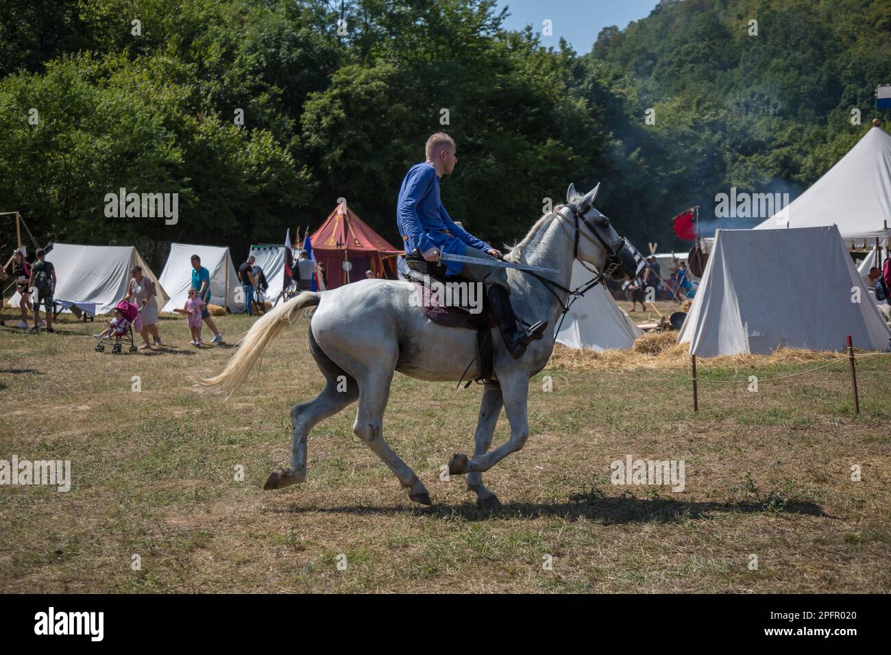 A man riding his white horse Stock Photo - Alamy