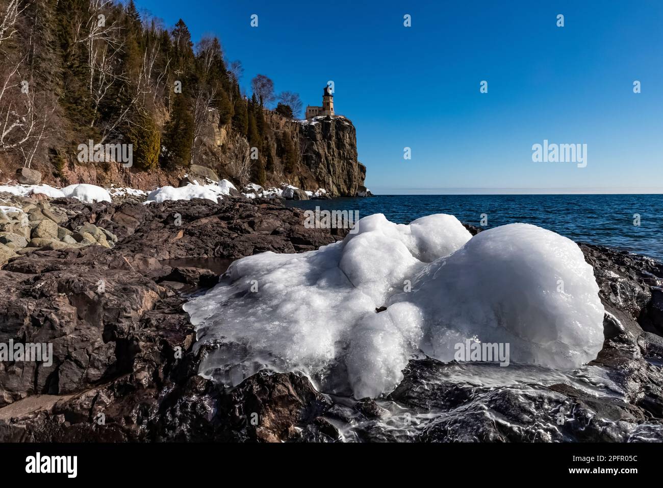 Ice left by water splashed up from waves below Split Rock Lighthouse on ...