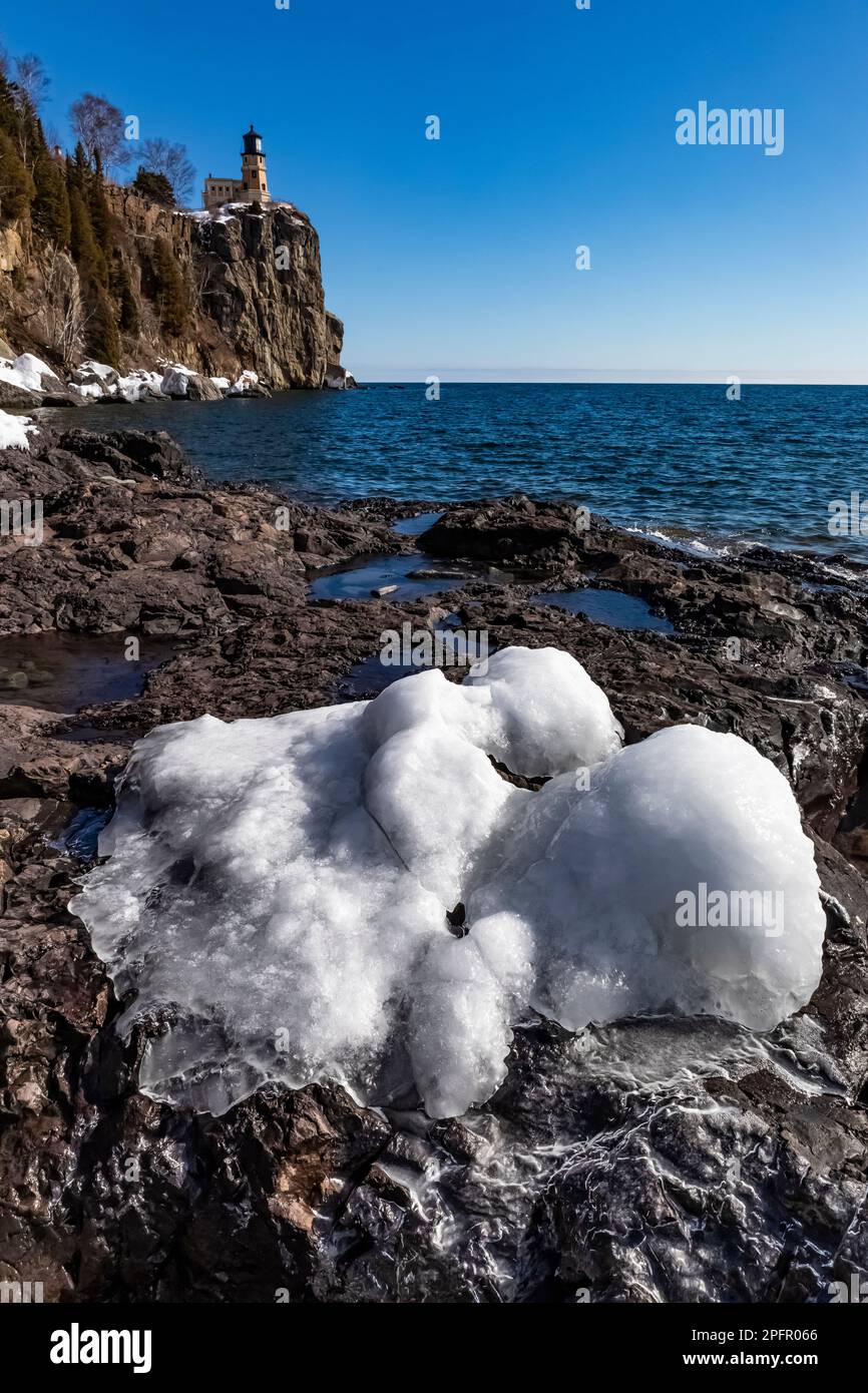 Ice left by water splashed up from waves below Split Rock Lighthouse on ...