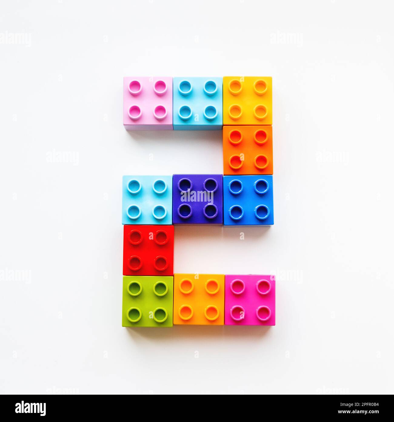 Number Two made of colorful constructor blocks. Toy bricks lying in ...