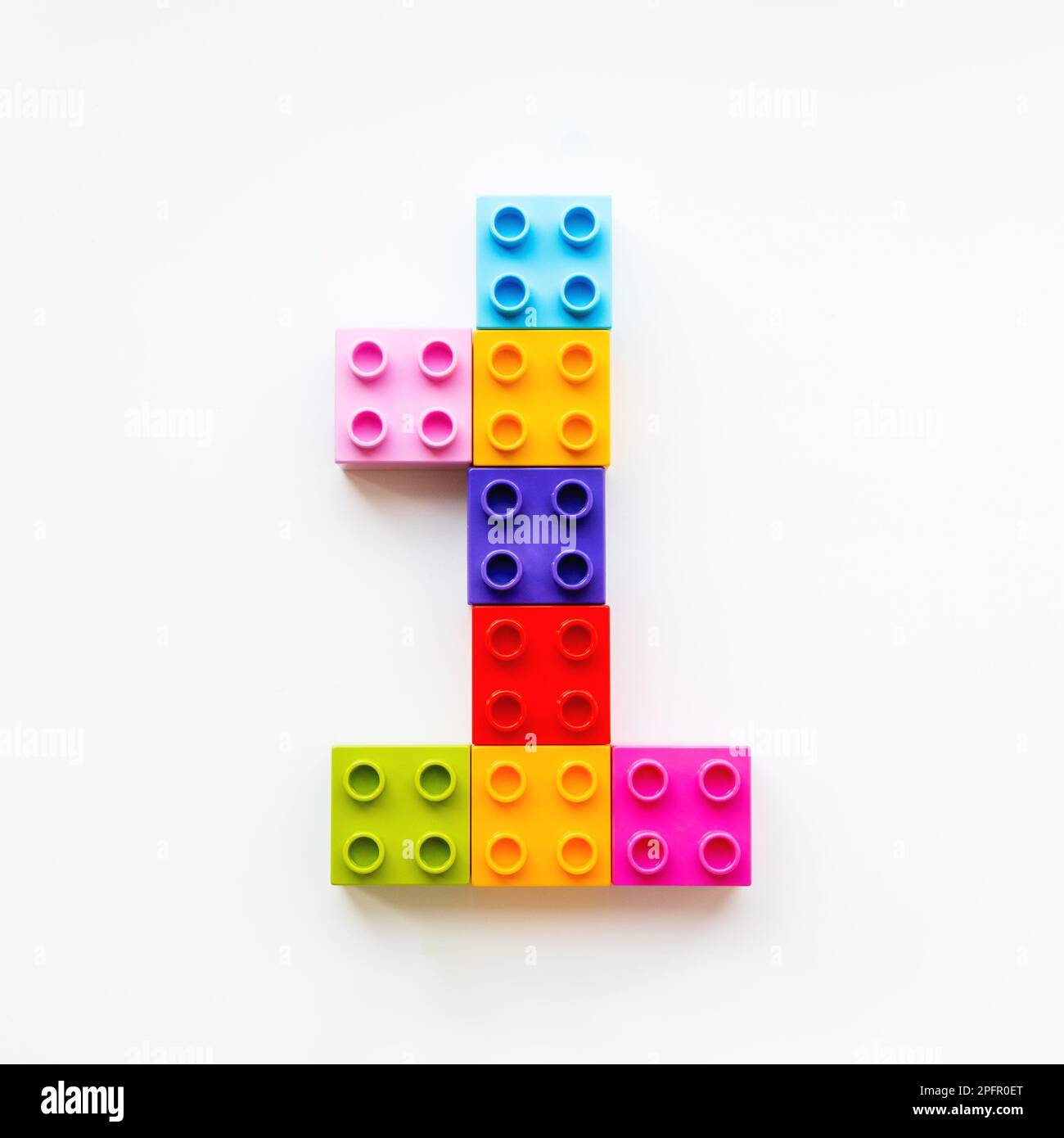 Number One made of colorful constructor blocks. Toy bricks lying in ...