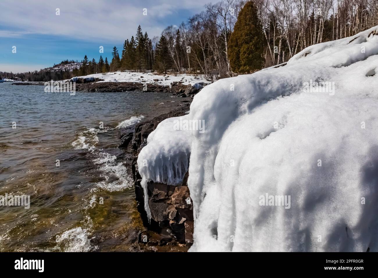 Ice left by water splashed up from waves below Split Rock Lighthouse on ...