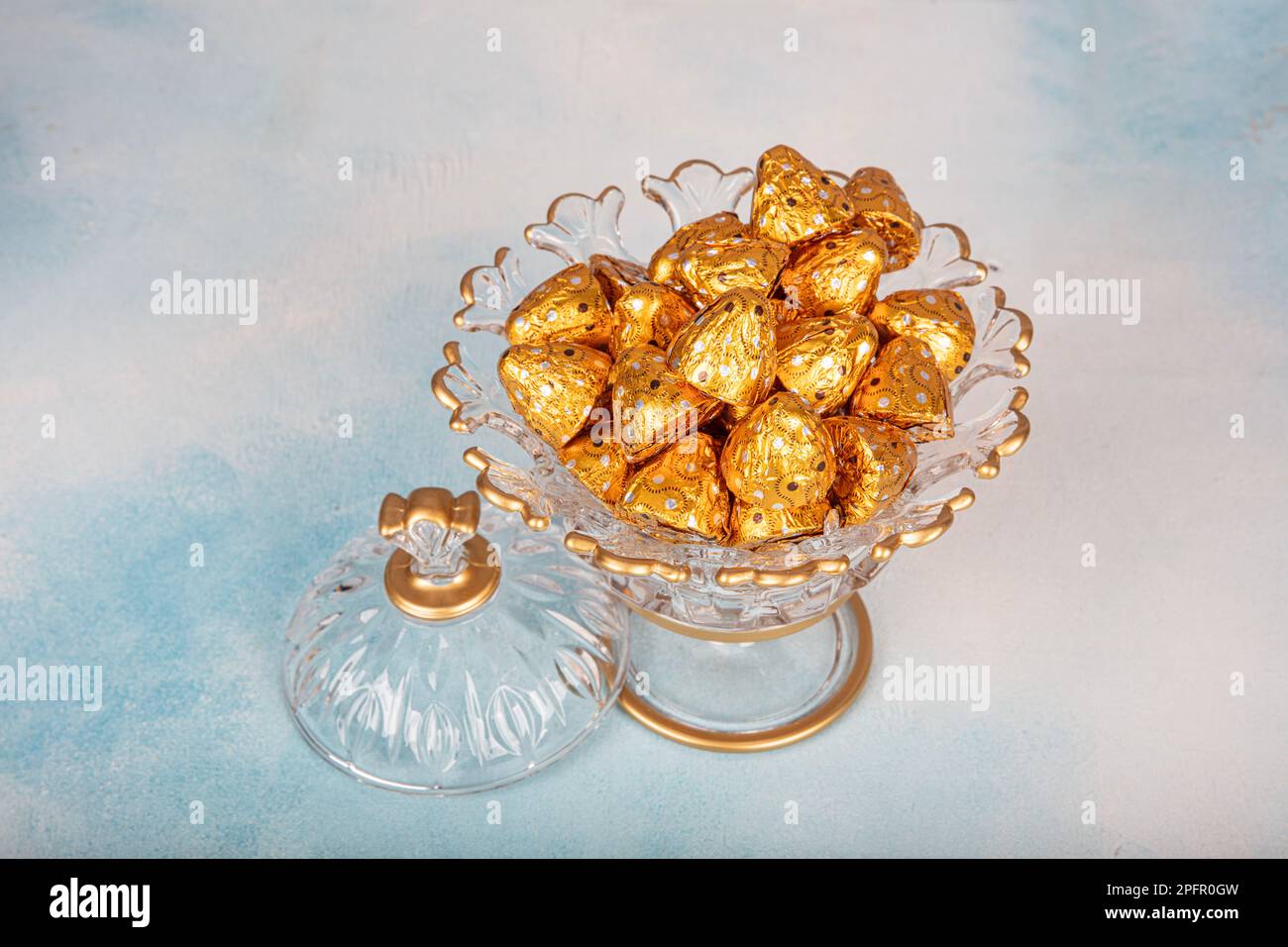 Chocolates wrapped in foil in luxury candy. Chocolate candies in a box ...