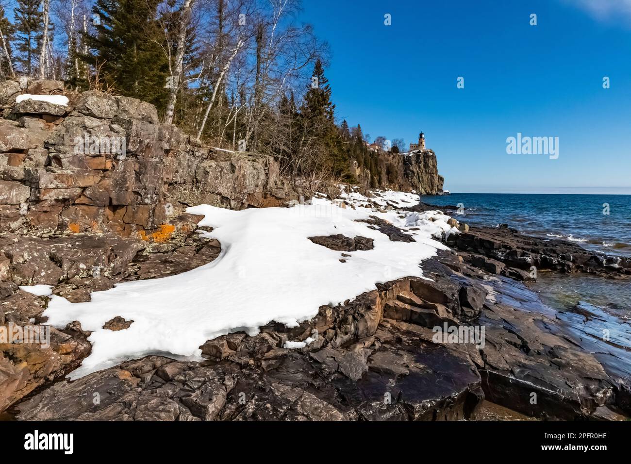 Ice left by water splashed up from waves below Split Rock Lighthouse on ...