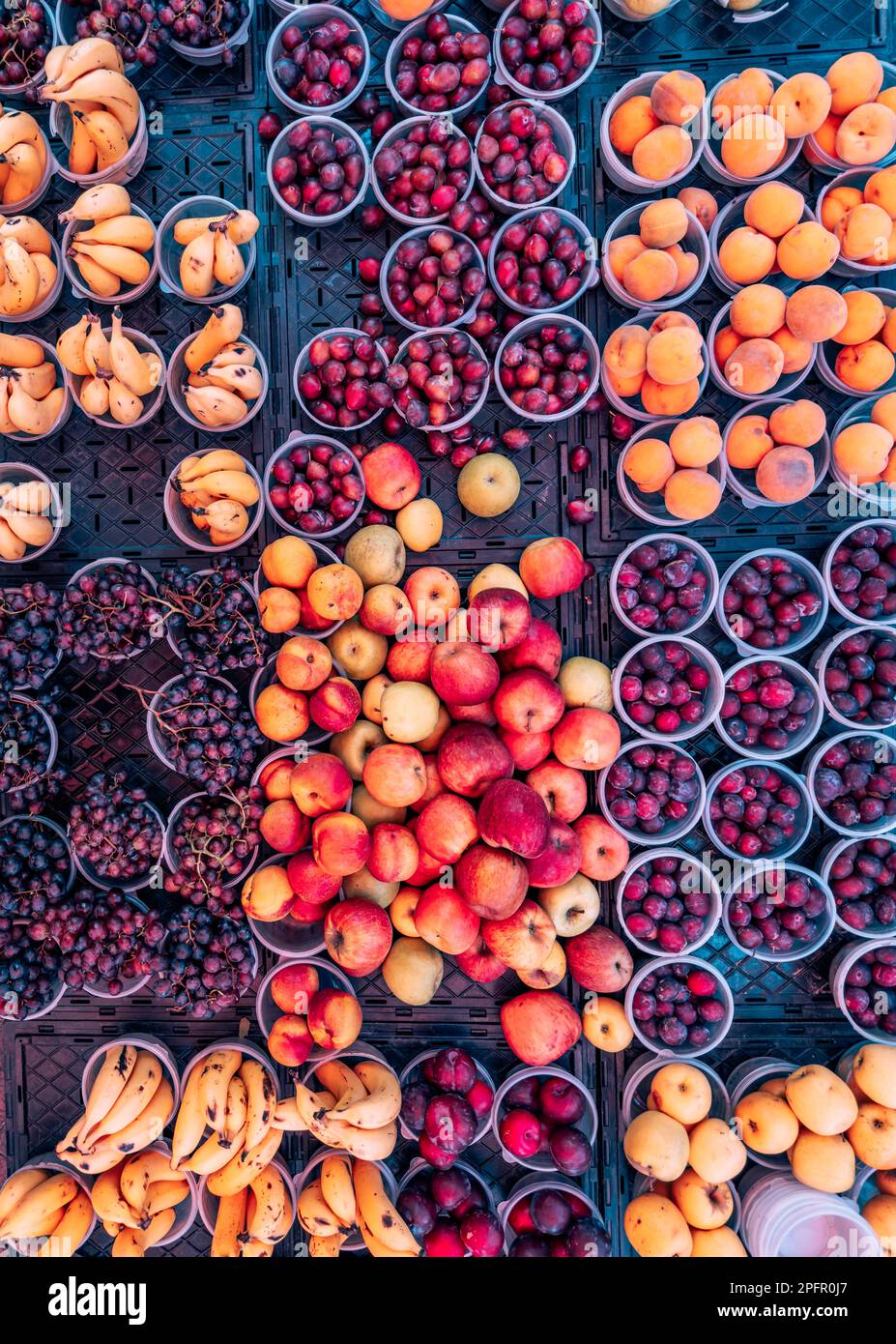 Tubs of fresh fruit such as grapes, pears, plums, peaches and bananas ...