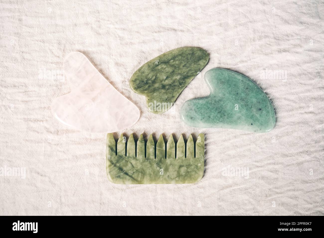 Natural stone gua sha tools for facial acupuncture massage Stock Photo ...