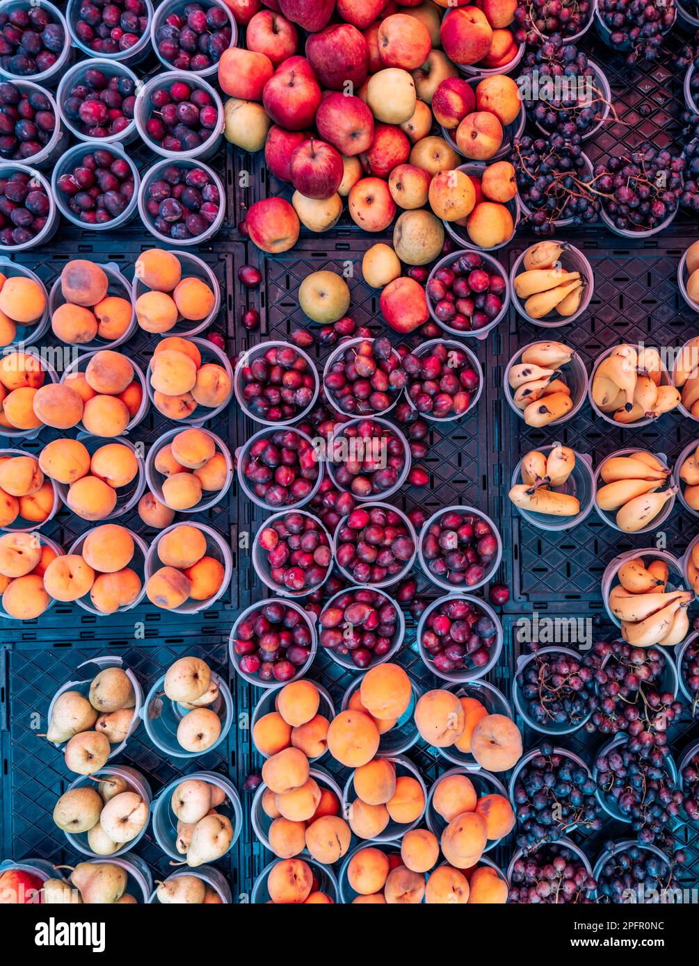 Tubs of fresh fruit such as grapes, pears, plums, peaches and bananas ...