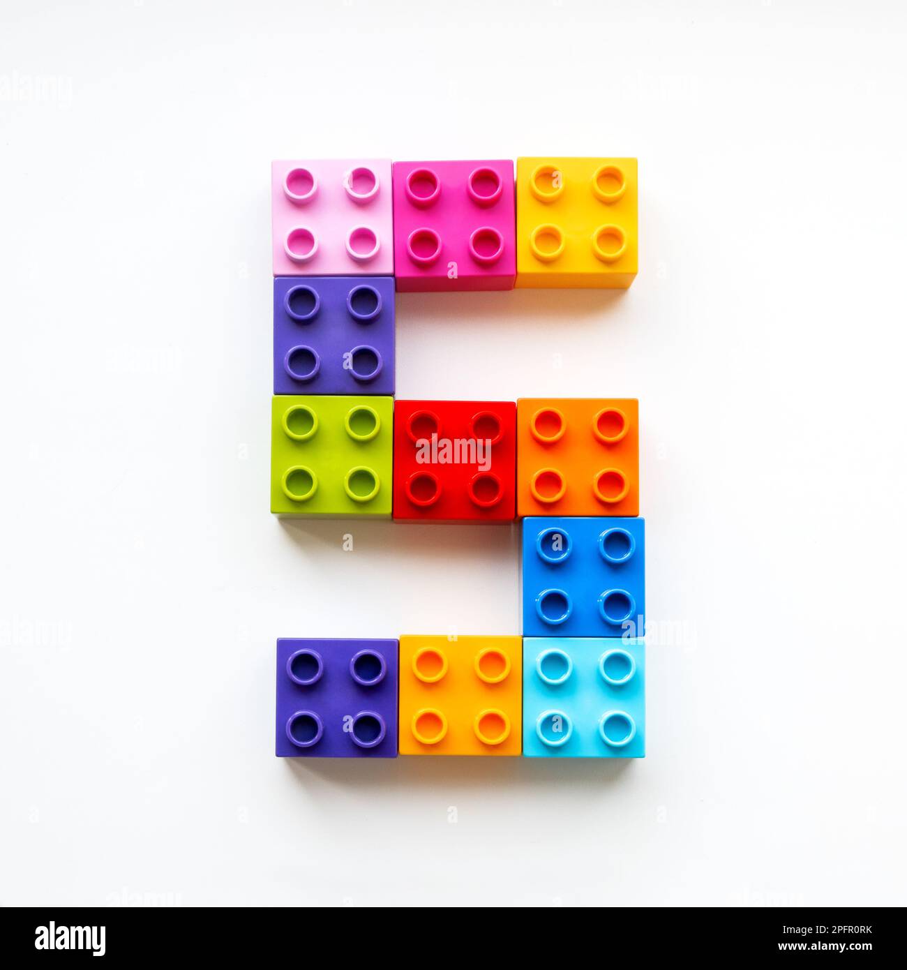 Number Five made of colorful constructor blocks. Toy bricks lying in ...