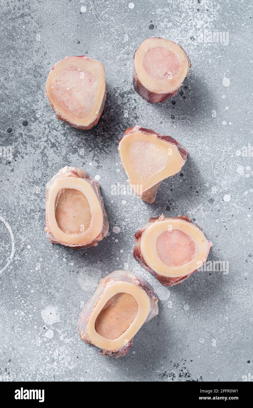 Raw calf Marrow bones on butcher table. Gray background. Top view Stock ...