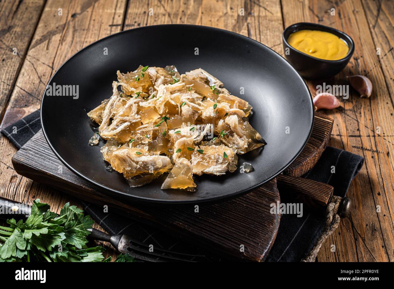 Chicken meat jelly in plate with mustard. Wooden background. Top view ...