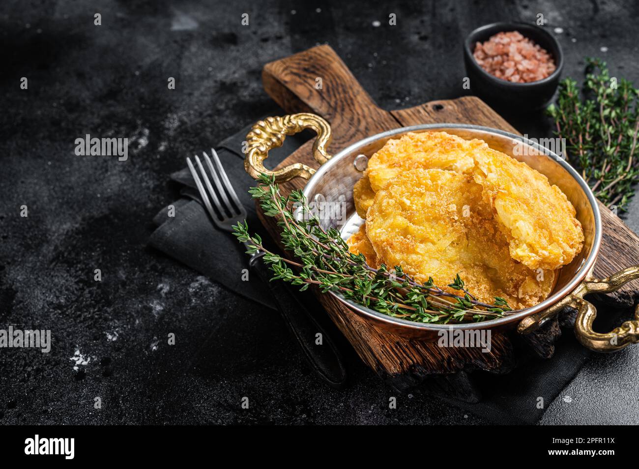 Fried Hash brown potato, hashbrown in a skillet. Black background. Top ...