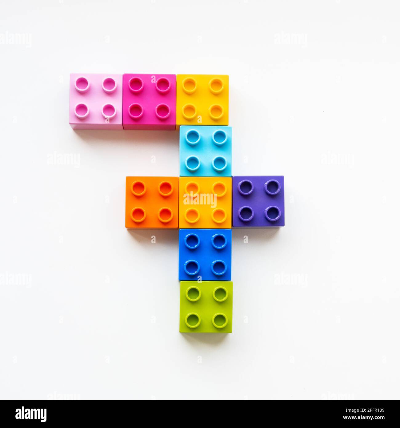 Number Seven made of colorful constructor blocks. Toy bricks lying in ...
