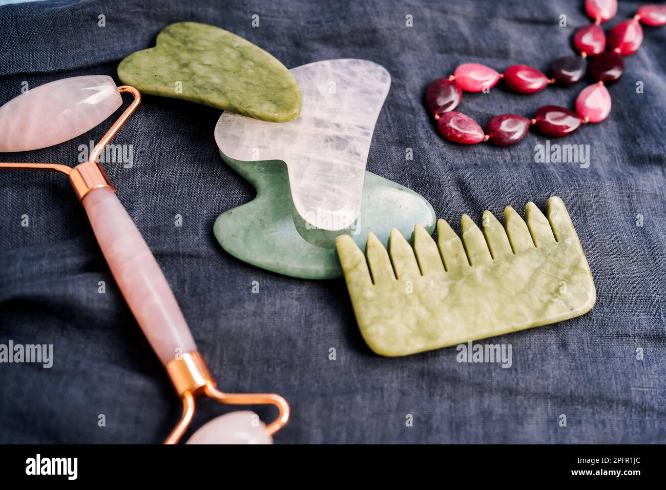 Natural stone gua sha tools for facial acupuncture massage Stock Photo ...