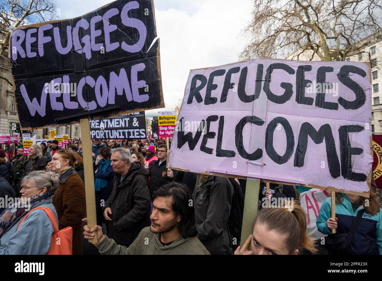 London, UK. 18 March 2023. People with signs take part in a 'Resist ...