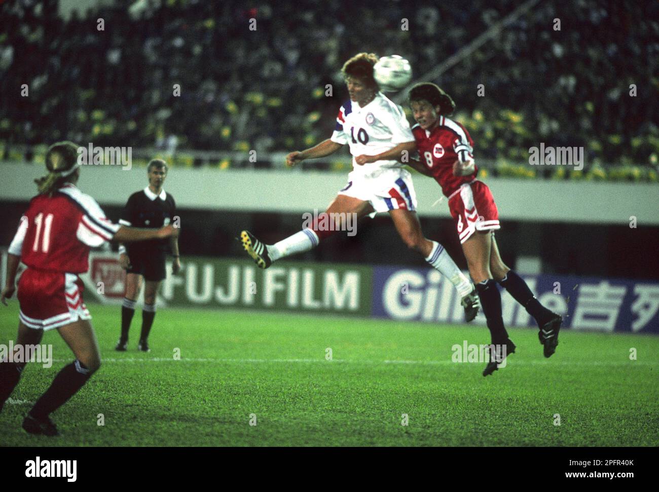 Michelle Akers-Stahl (USA) rises for a header during the United States ...