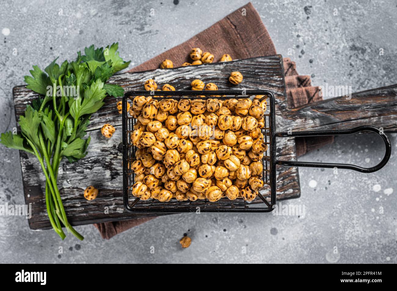Healthy snack roasted spicy chickpeas in a basket. Gray background. Top ...