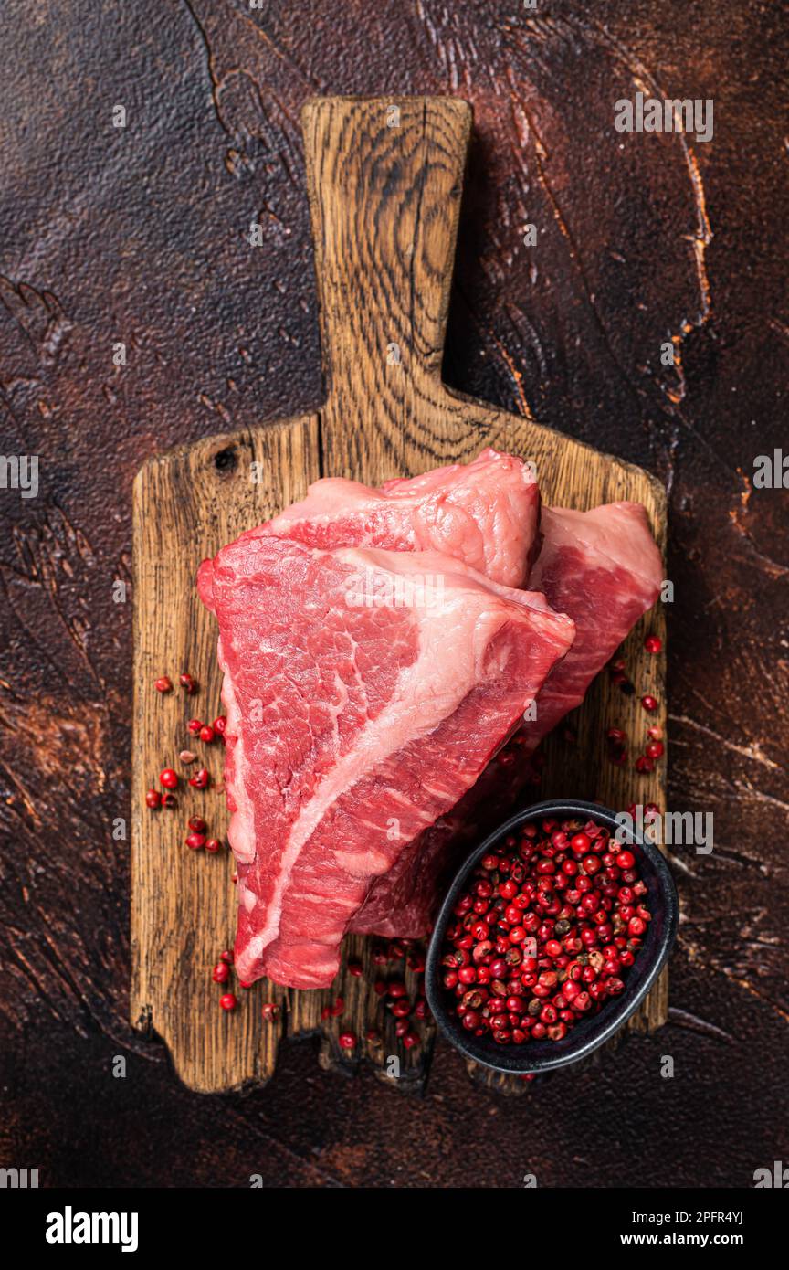 Raw sirloin beef cut, Silverside steak on a wooden board. Dark ...