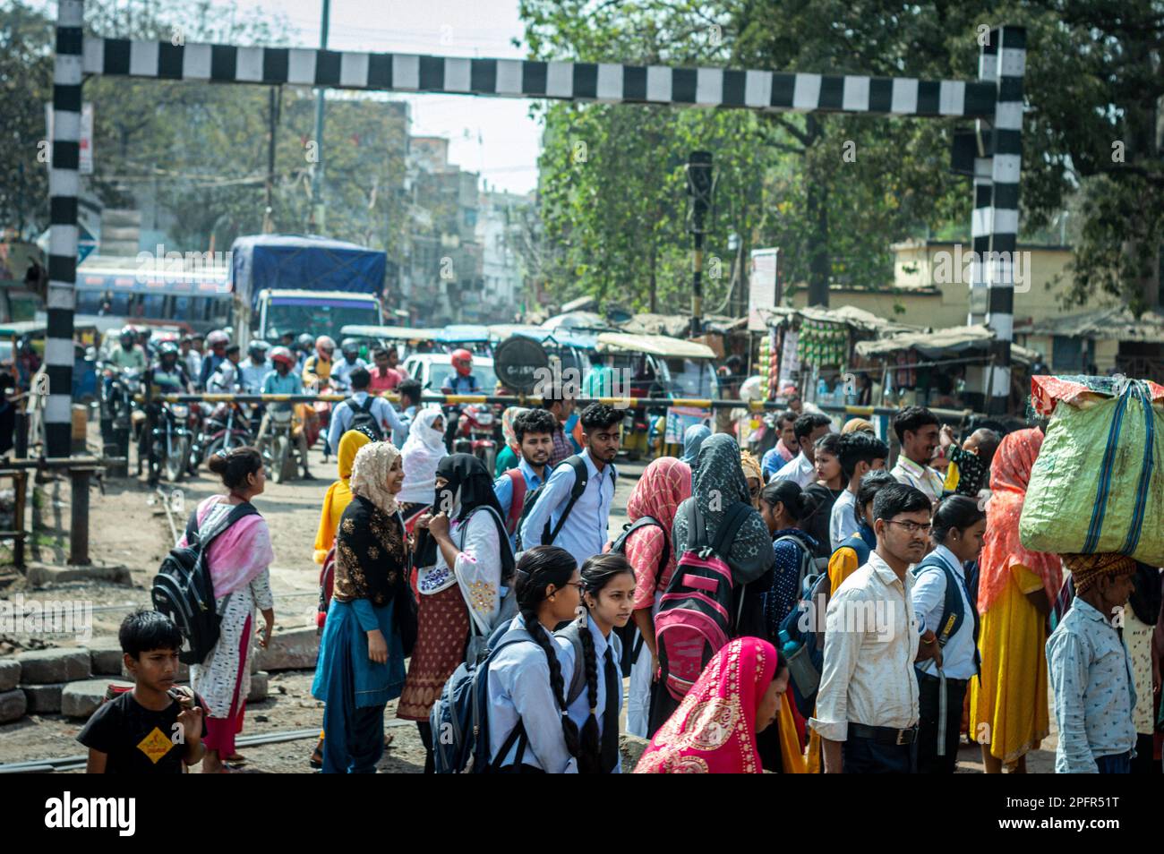 Crowd of People standing near an Indian Railway level crossing. Focus ...