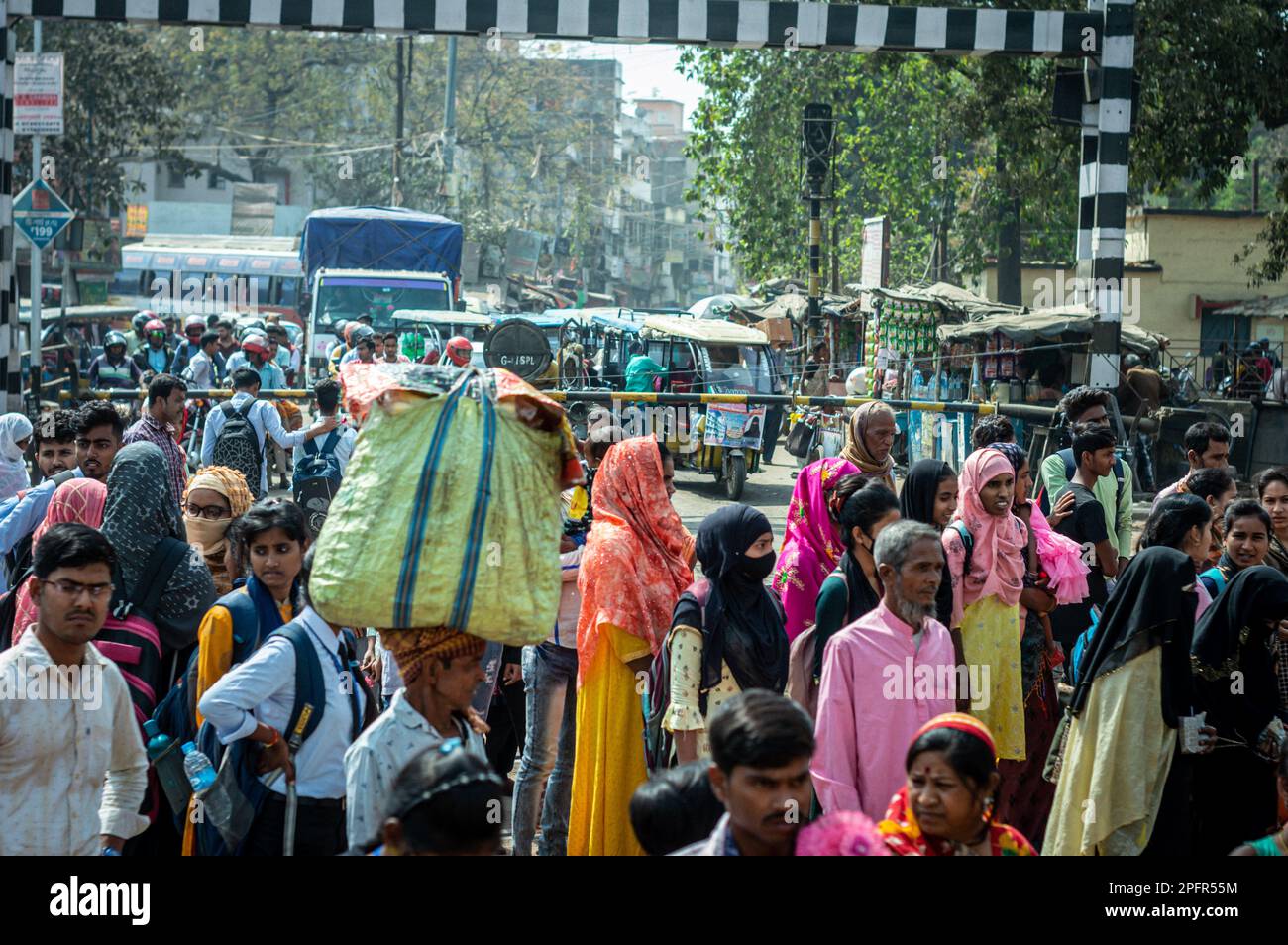 Crowd of People standing near an Indian Railway level crossing. Focus ...