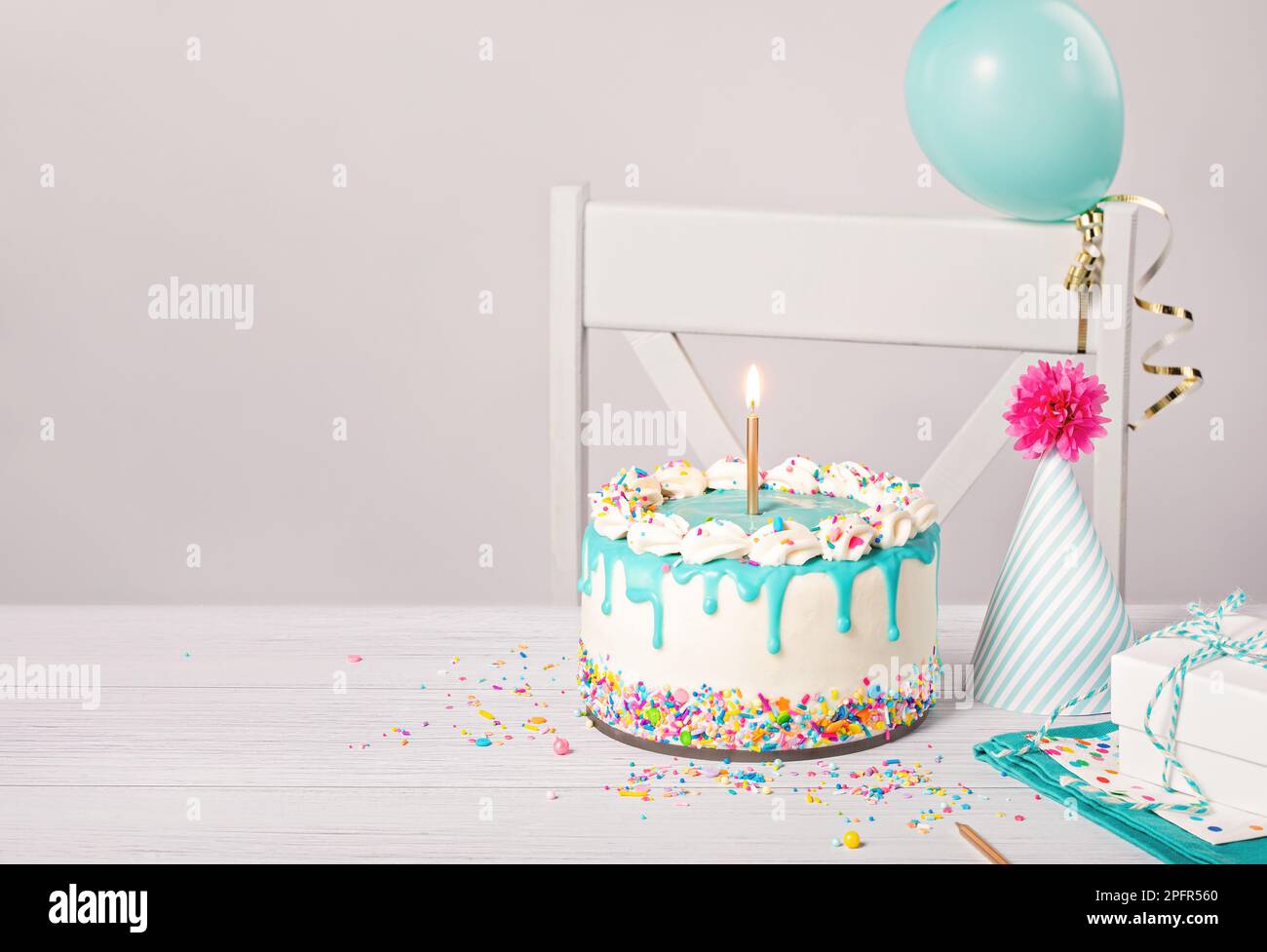 Birthday party table setting with a vanilla buttercream cake, teal blue ...